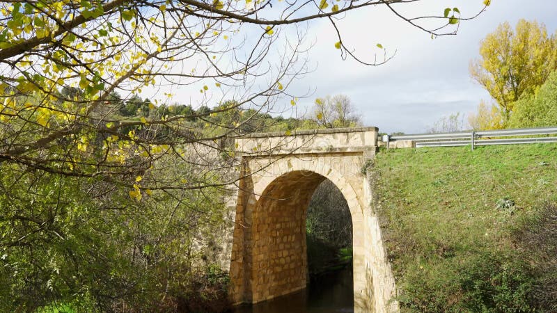A Small Stream that Passes through the Arch of a Stone Bridge in the ...