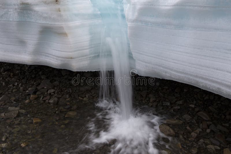 A Small Stream of Water Falling from the Ice Formation. Stock Photo ...