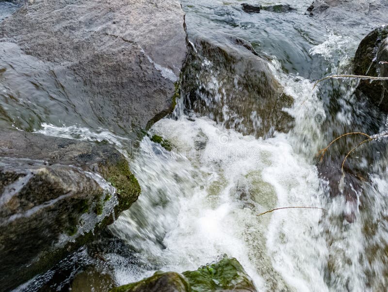 A Small Stream of Water Flowing Over Rocks in a Stream Stock Image ...
