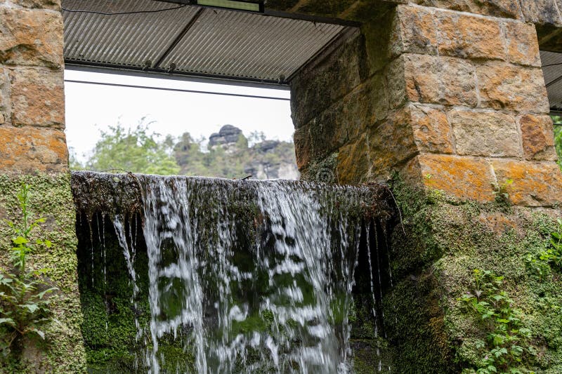 A Small Stream of Water Flows Down a Stone Wall Stock Photo - Image of ...