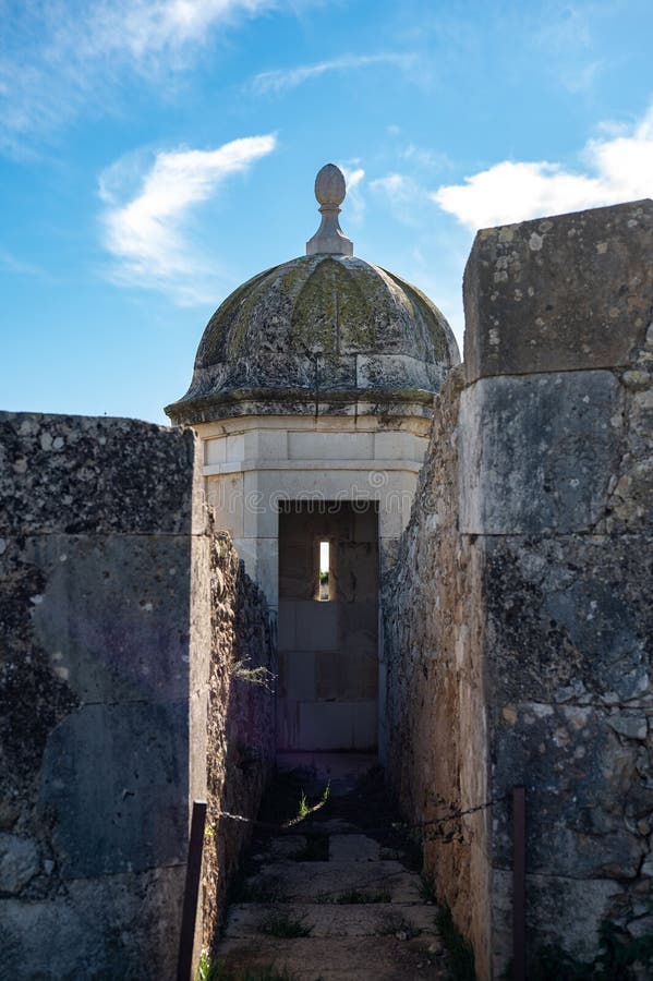 Small Structure with Door and Open Window on Stone Wall, with Grassy ...