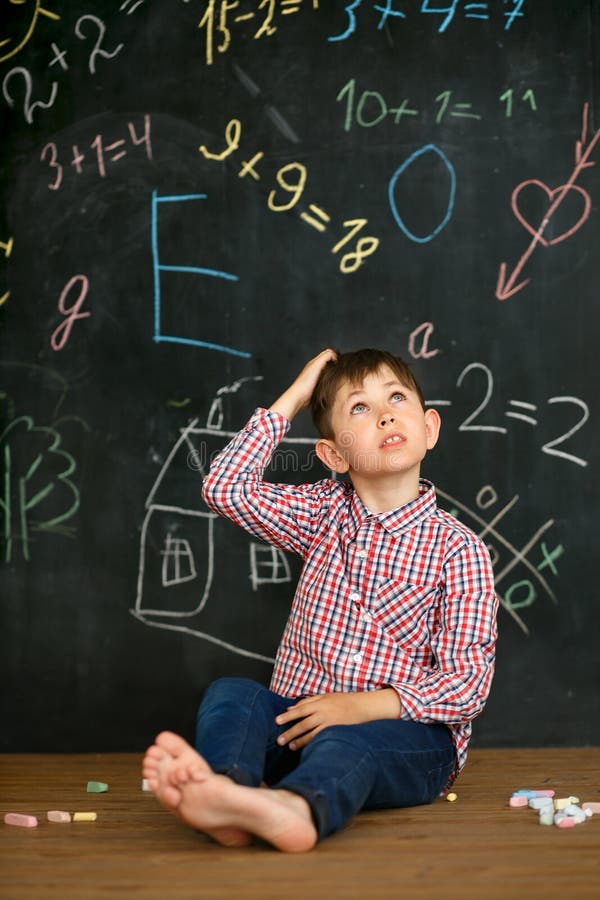 A Small Student Solves a Difficult Task. Stock Image - Image of ...