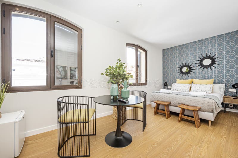 Small Studio with King Size Bed and Black Multipurpose Table in a ...