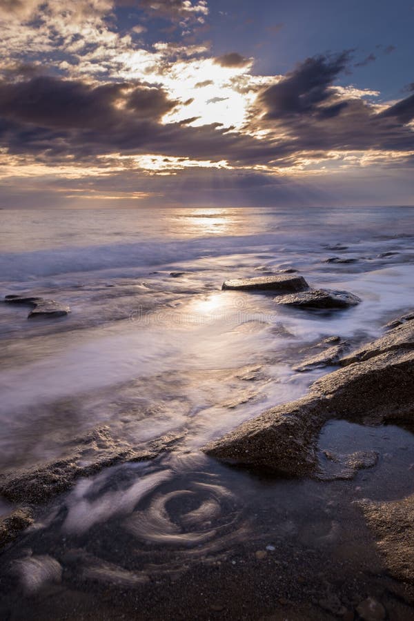 Small Swirl On The Beach With Dramatic Sky.Corfu Greece. Stock Photo ...