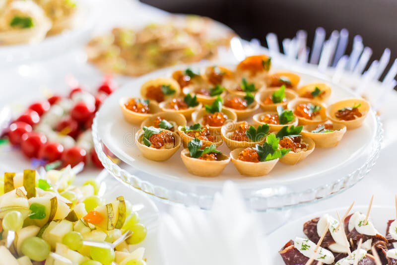 A Small Table with a Delicious Buffet of Canapes, Caviar, Sandwiches ...