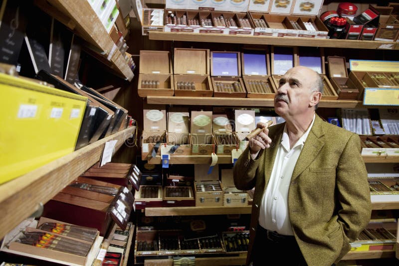 Small Tobacco Store Owner Looking at Cigar Boxes on Display in Shop ...