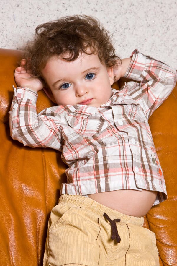 Small Toddler with on a Leather Brown Sofa Stock Image - Image of child ...
