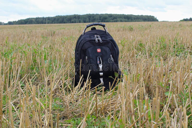A Small Tourist Backpack Stands on the Ground in the Middle of a ...