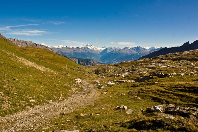 Small Trail Passing through the Mountains with the Snowy Peaks of the ...