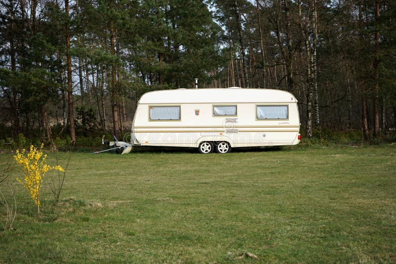 Small Trailer Home Parked on the Grass in a Forest on Front of the ...