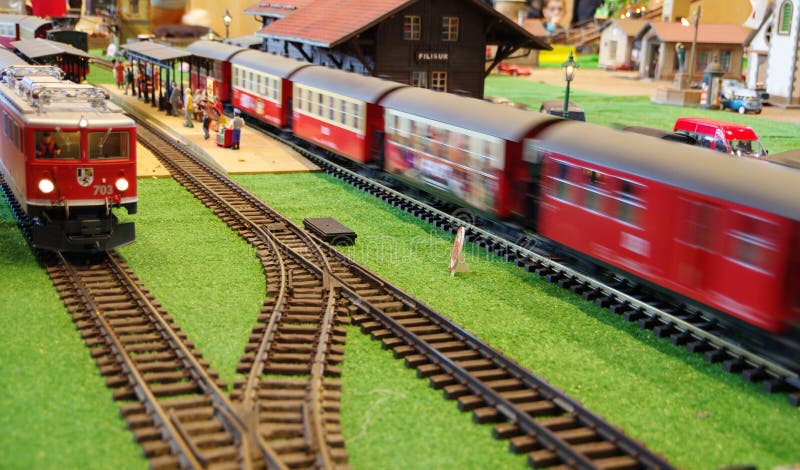 Small Train Station on a Model Railway Layout with a Train Passing ...