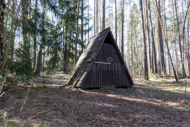 A Small Triangular Wooden House in the Middle of the Forest Stock Photo ...