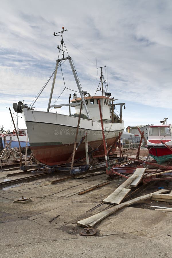 Small vessel in dry dock stock image. Image of messy - 24534167