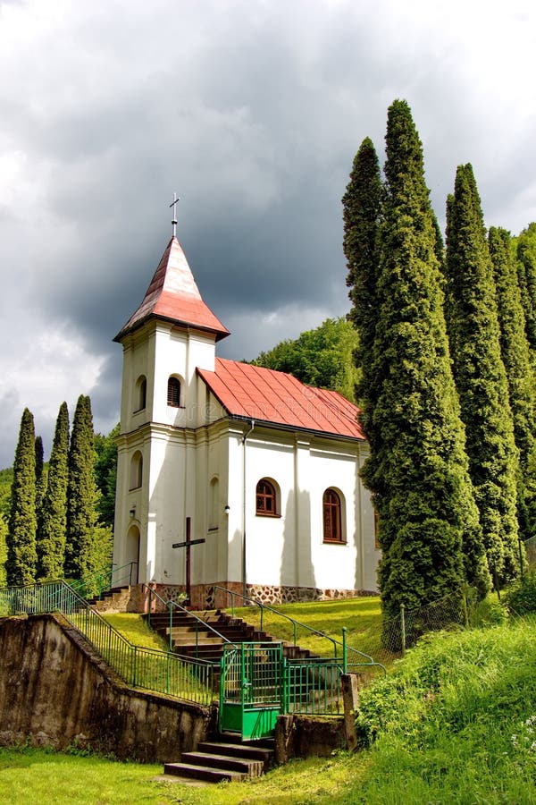 Small Village Church Surrounded by Trees with Cloudscape on Background ...
