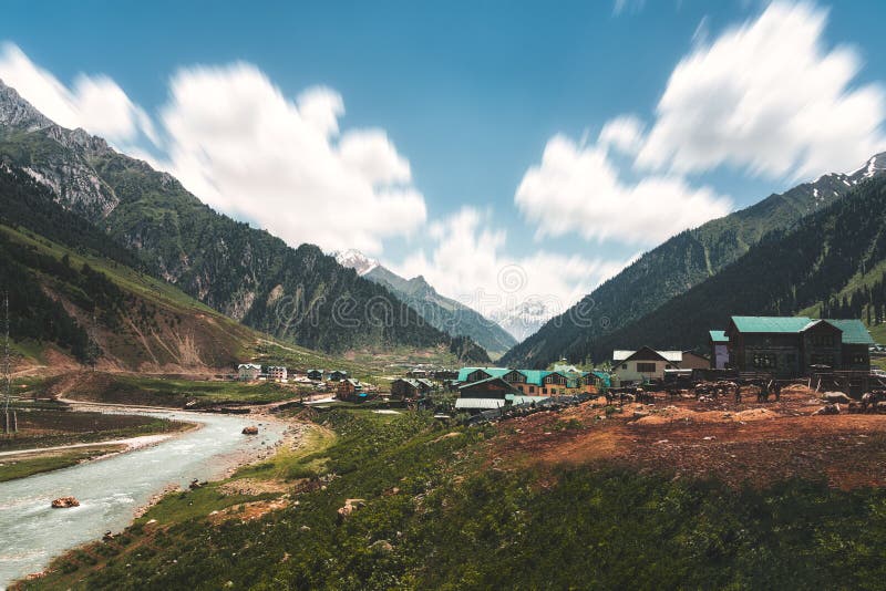 Small Village Near a River Flowing Trough Mountains Stock Image - Image ...