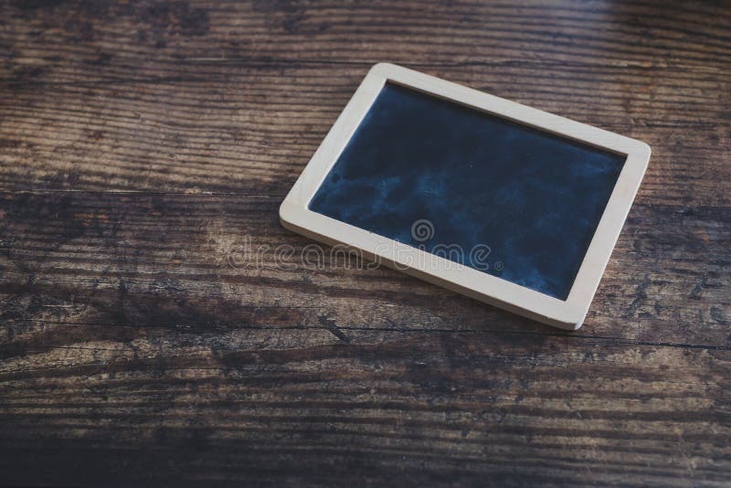 Small Vintage Chalk Blackboard on Rustic Wooden Table Stock Photo ...