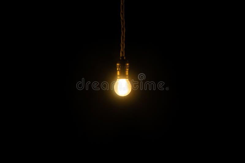 Small Vintage Glowing Light Bulb on Black Background. Electricity ...