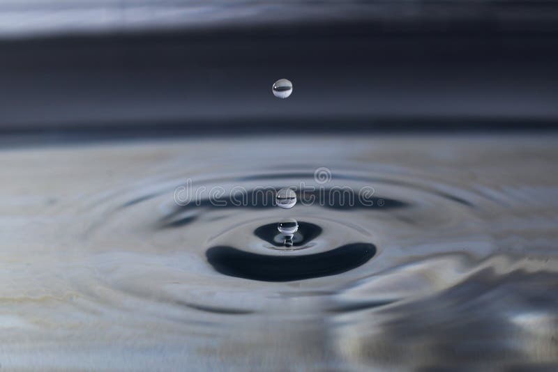 A Small Water Drop Fall on Water Surface Stock Image - Image of ...