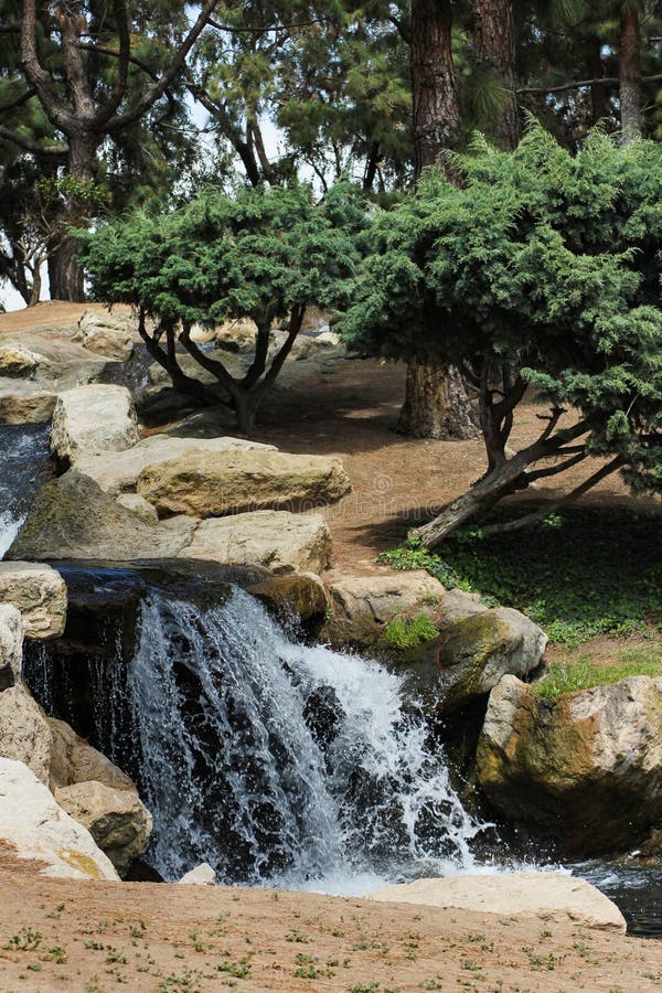 Small Waterfall Cascading Down Boulders into Pool of Water in Public ...
