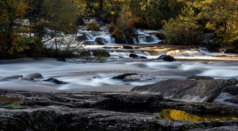 Small Waterfall Cascading Down a Rocky Outcropping, Surrounded by Lush ...