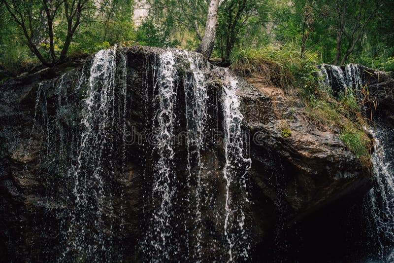 Small Waterfall Cascading Over Rocky Cliff Stock Photo - Image of water ...