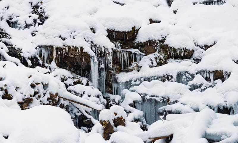 Small Waterfall of Cold Water Flow among the Stones Covered with Snow ...