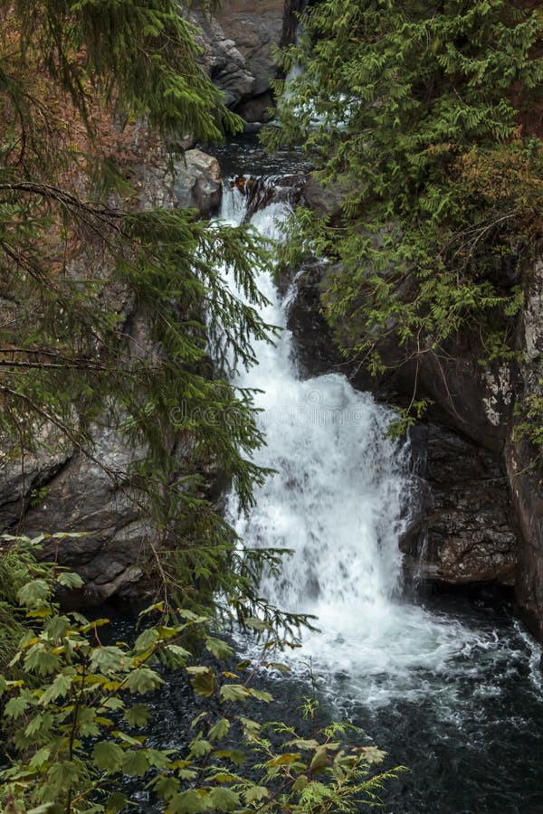 Waterfall Cascades into Deep Blue Pools in Forest Stock Photo - Image ...