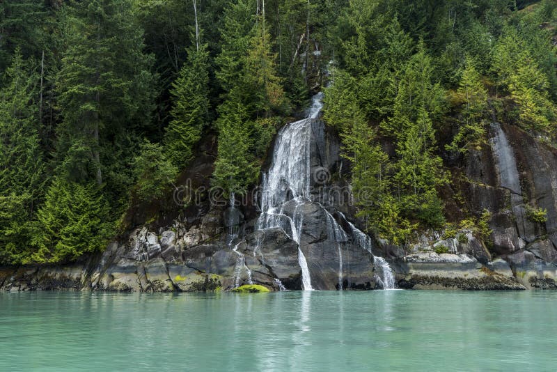 Small Waterfall Falling into a Glacial Water Stock Photo - Image of ...