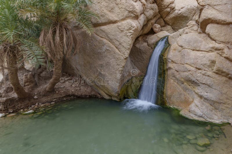 A Small Waterfall Hidden between Rocks in the Desert Stock Image ...