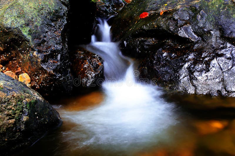 Small Waterfall Flowing Over Rocks in Nature. Stock Photo - Image of ...
