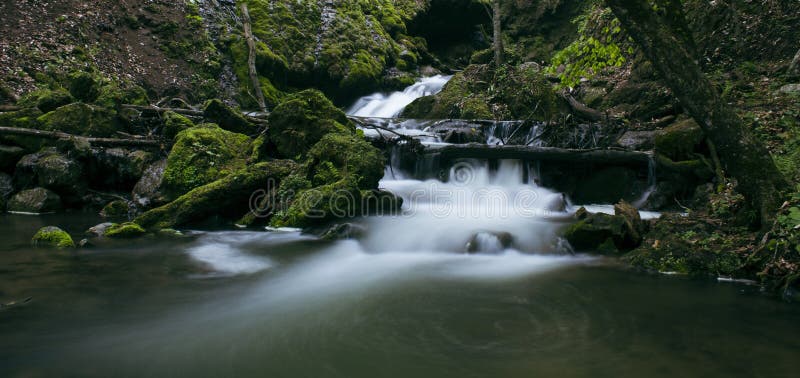 A Small Waterfall Flows through the Forest Stock Image - Image of ...