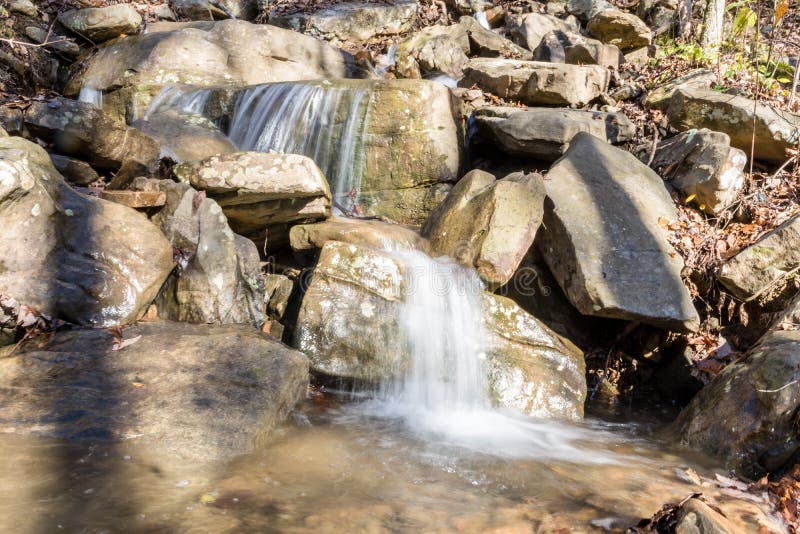 Small Waterfall Flowing into Creek Stock Photo - Image of creek, daisy ...