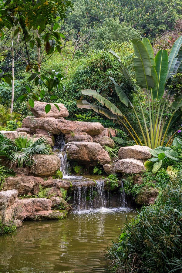 Small Waterfall from Rock Mountain in a Green Tropical Background Stock ...