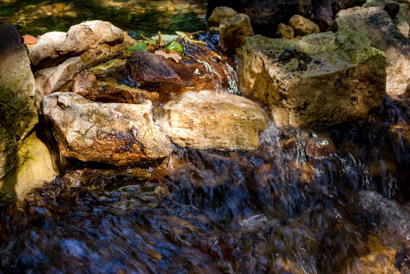 A Small Waterfall on a Stream Lit by the Rays of the Sun Stock Image ...