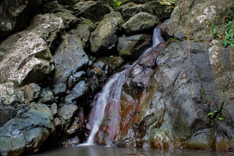 Small Waterfall Surrounded by Big Rocks in the Forest Stock Photo ...