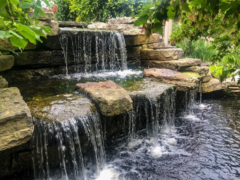 Small Waterfall Trickling Down Rocks Into Pond Stock Image - Image of ...
