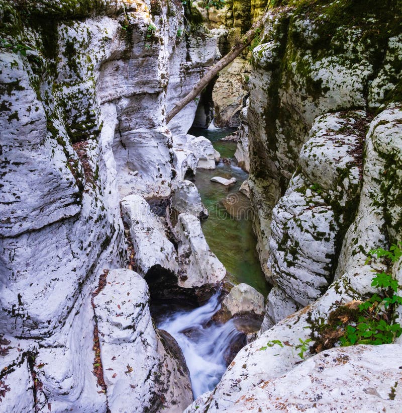 Small Waterfall between White Rocks with Moss. Smooth Water. Stock ...