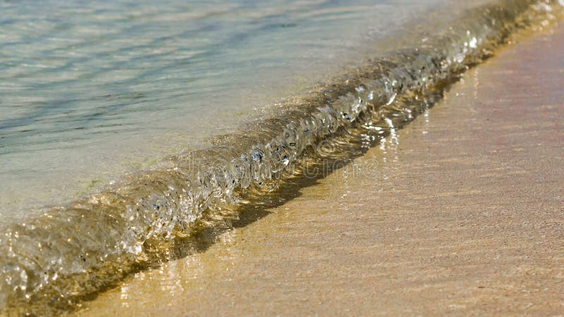 A Small Wave with Foam Rolls on the Sea Pebbles Stock Image - Image of ...