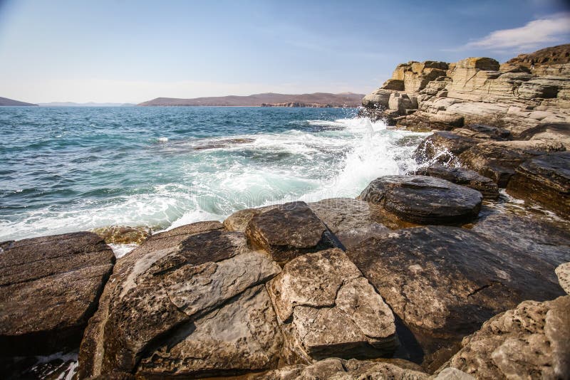 Small Wave Crashing Against the Rocks with Splashes in Selective Focus ...