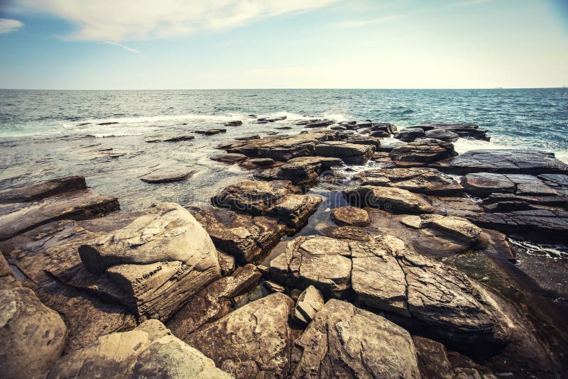 Small Wave Crashing Against the Rocks with Splashes in Selective Focus ...