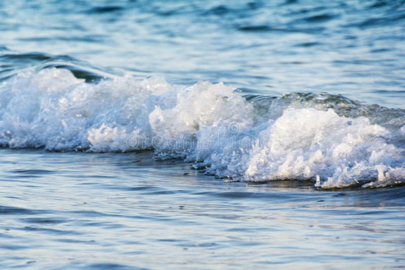 A Small Wave with Foam Rolls on the Sea Pebbles Stock Image - Image of ...
