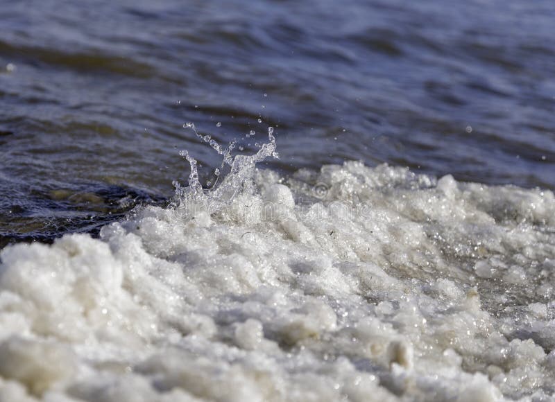 A Small Wave with Foam Rolls on the Sea Pebbles Stock Image - Image of ...