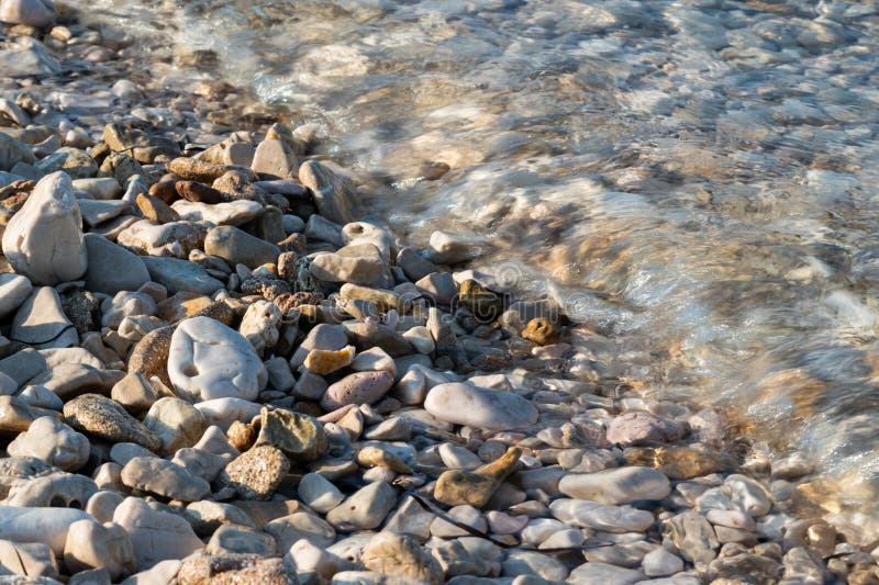 Sea Water Covers Beach Stones Stock Image - Image of calm, sunny: 334342437