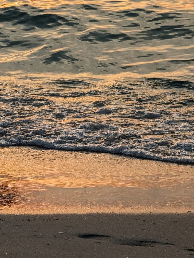 A Small Wave in the Sunset Rays of the Sun Stock Photo - Image of rock ...