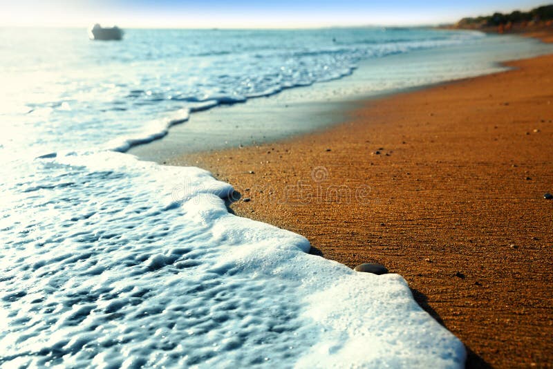 Small waves on the beach stock photo. Image of coastline - 33790264