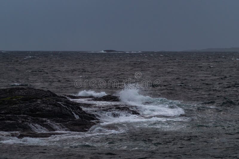 Small Waves Hitting Dark Rocks from the Ocean Stock Image - Image of ...