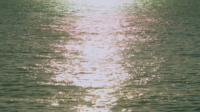 Small Waves on Water Surface with Suns Rays. Natural Background with ...