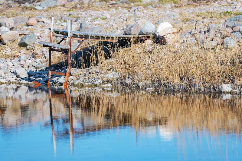 Old Weathered Jetty Posts Standing in Row on Beach Casting Shadow on ...