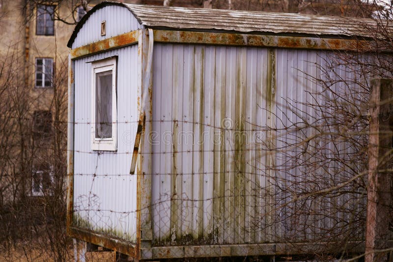 A Small White Building with a Broken Window, Suitable for Use in ...