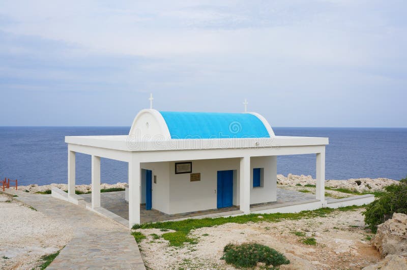 Small White Building in Front of the Water Surrounded by Grass and Moss ...